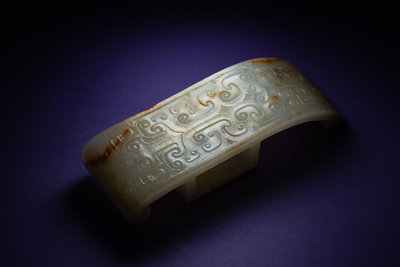 A Chinese White and Russet Jade Sword Slide, Jianzhi Lot 86