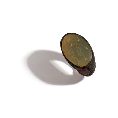 A Roman Copper Alloy and Chalcedony Finger Ring with the God Apollo Lot 180